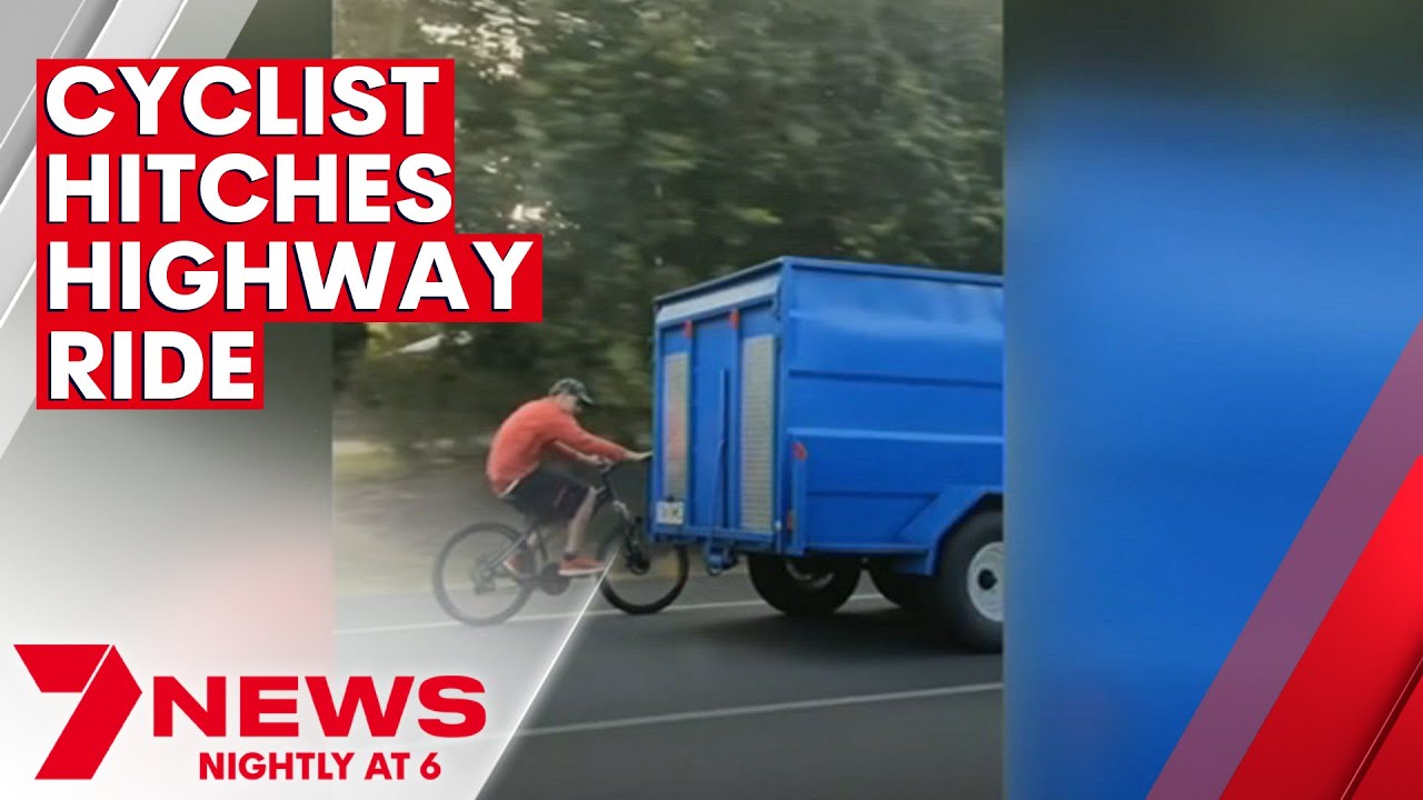 Cyclist filmed hitching a ride behind a car on the Bruce Highway ...