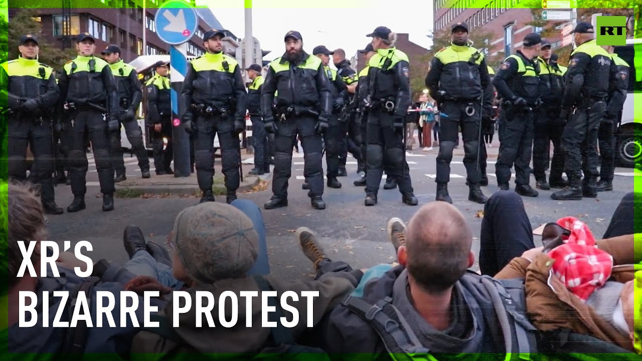 XR activists attach themselves to vehicles at protest in The Hague ...