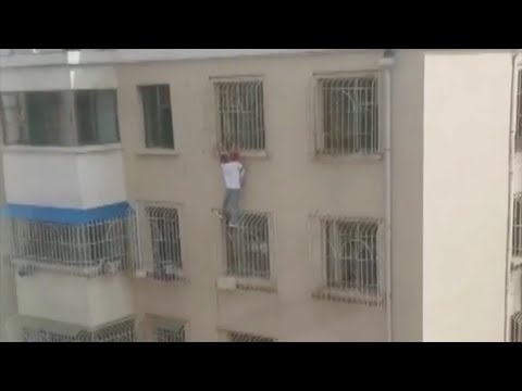 Man rescues a girl dangling from 6th-floor window in superhero-like act ...
