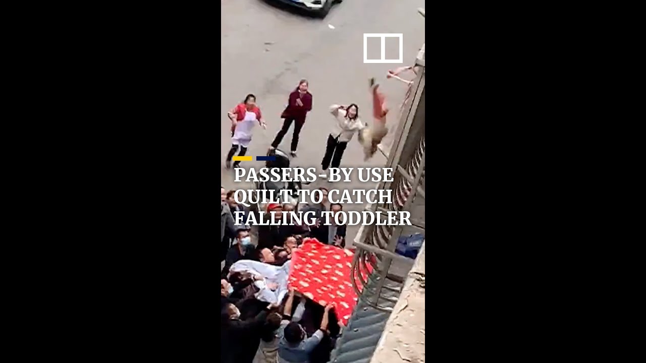 Passers-by use quilt to catch falling toddler in China #shorts - The ...
