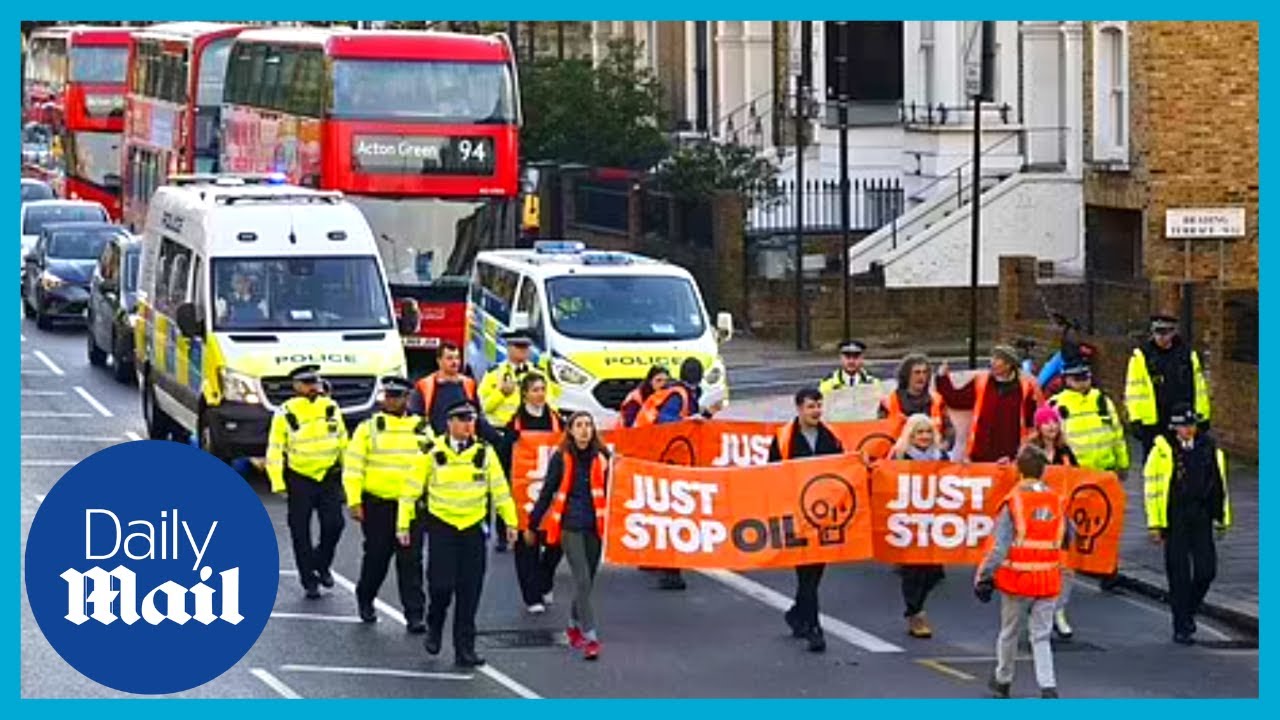 Just Stop Oil block London road as Met police walk side-by-side - The ...