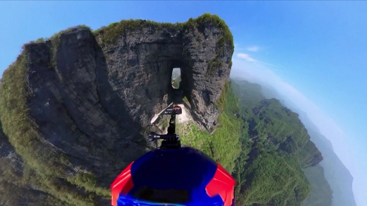 Chinese wingsuiter successfully flies through Tianmen Cave for first ...