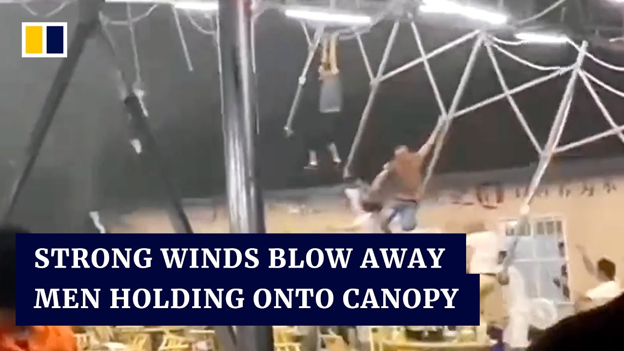 Strong winds in China blow away restaurant staff holding onto canopy ...