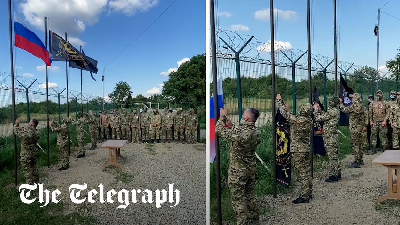 Wagner mercenaries lower flags at their base in Krosnadar in apparent ...