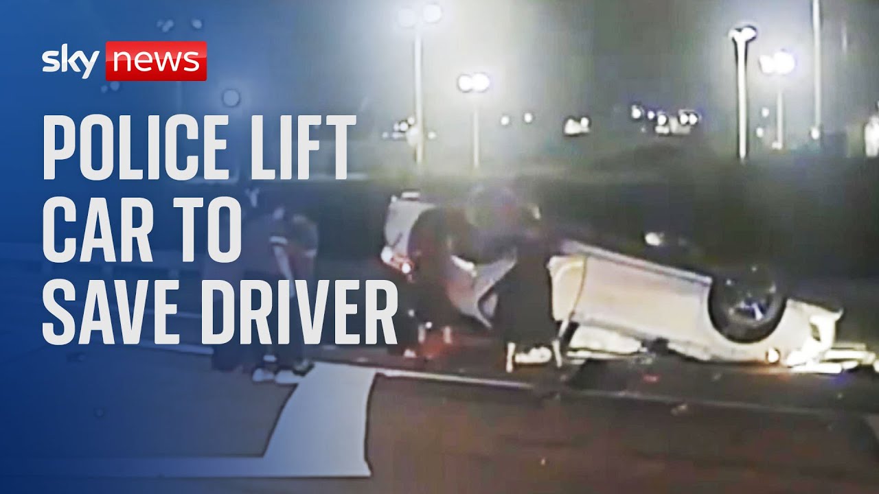 US: Police officers lift flipped car to save trapped driver - The ...