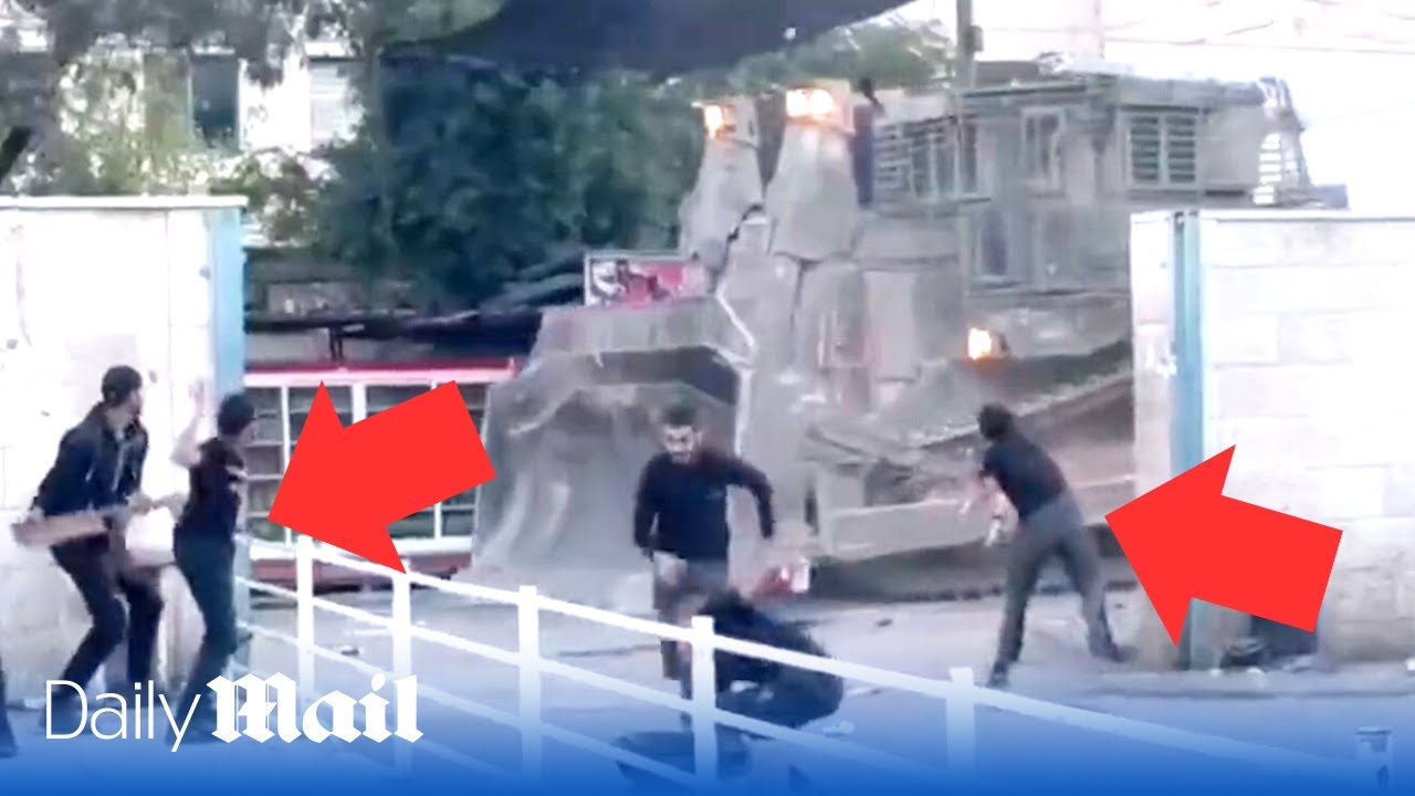 Furious protesters throw rocks at Israeli bulldozers in the West Bank ...