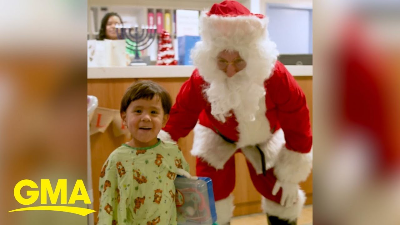 Watch the heartwarming moment a little boy runs up and hugs Santa Claus ...
